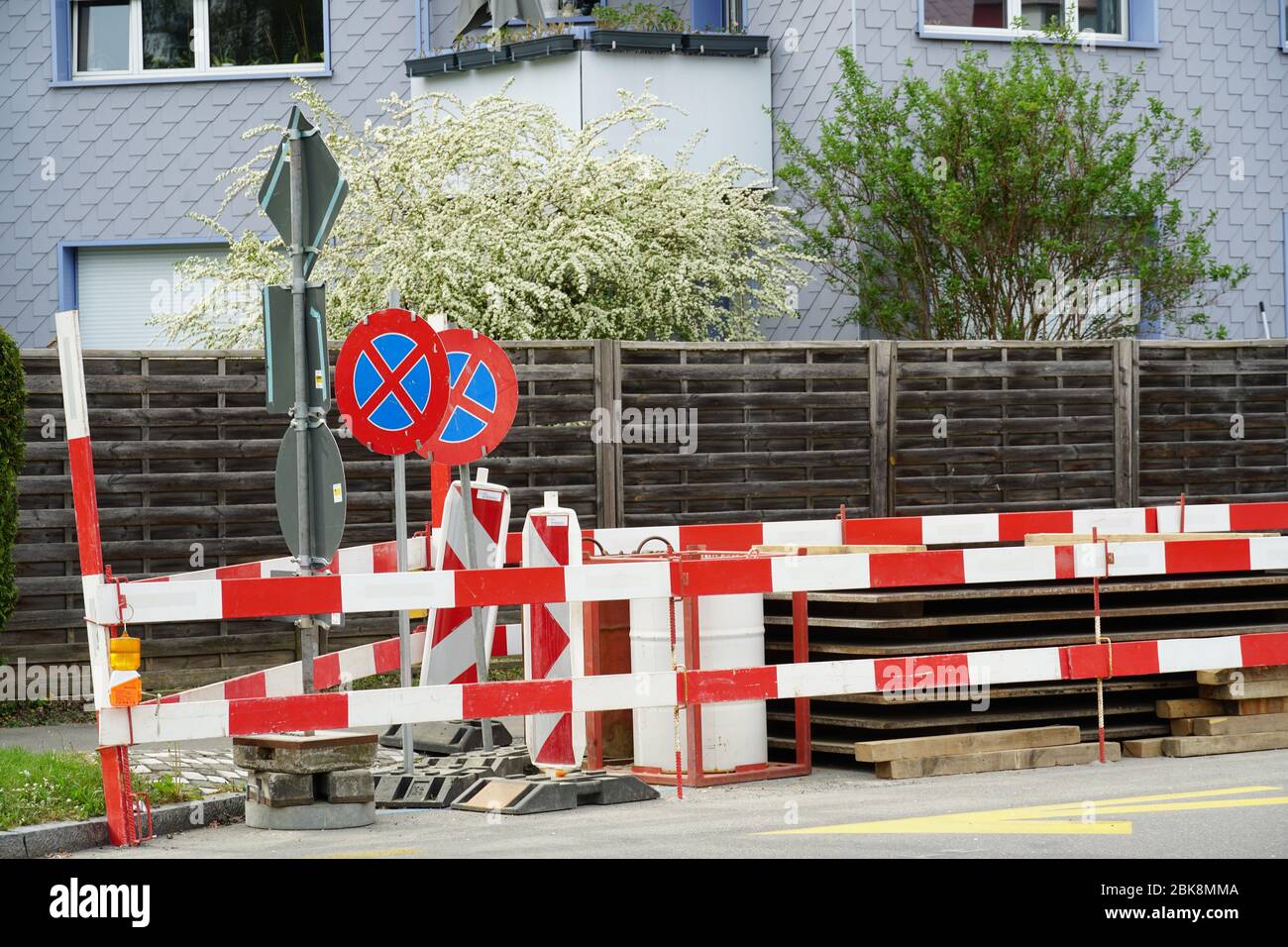 horizontal barrier planks in red and white and two traffic signs do not ...