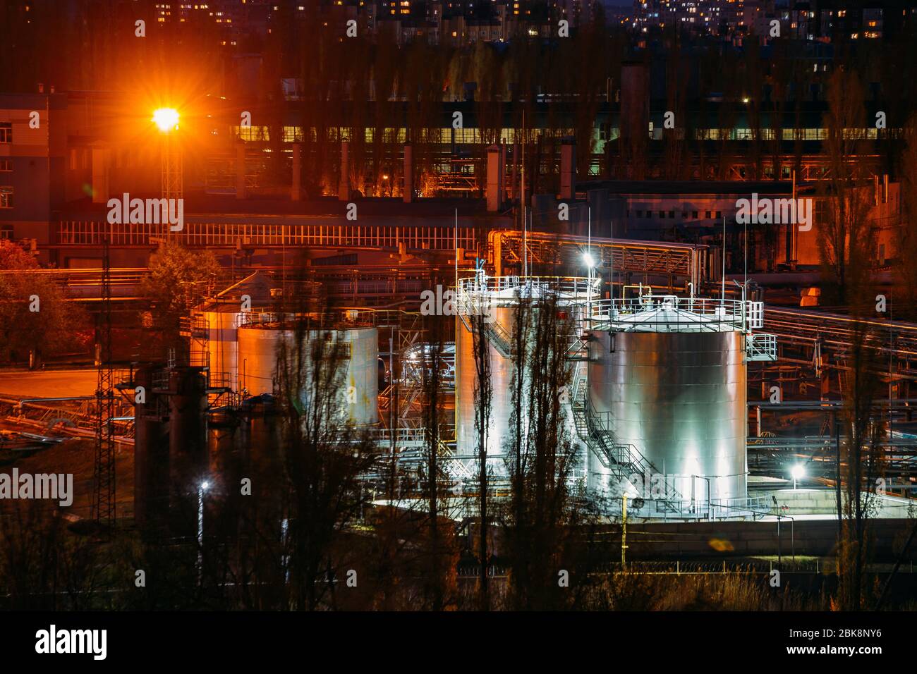 Storage tanks in chemical factory at night Stock Photo - Alamy