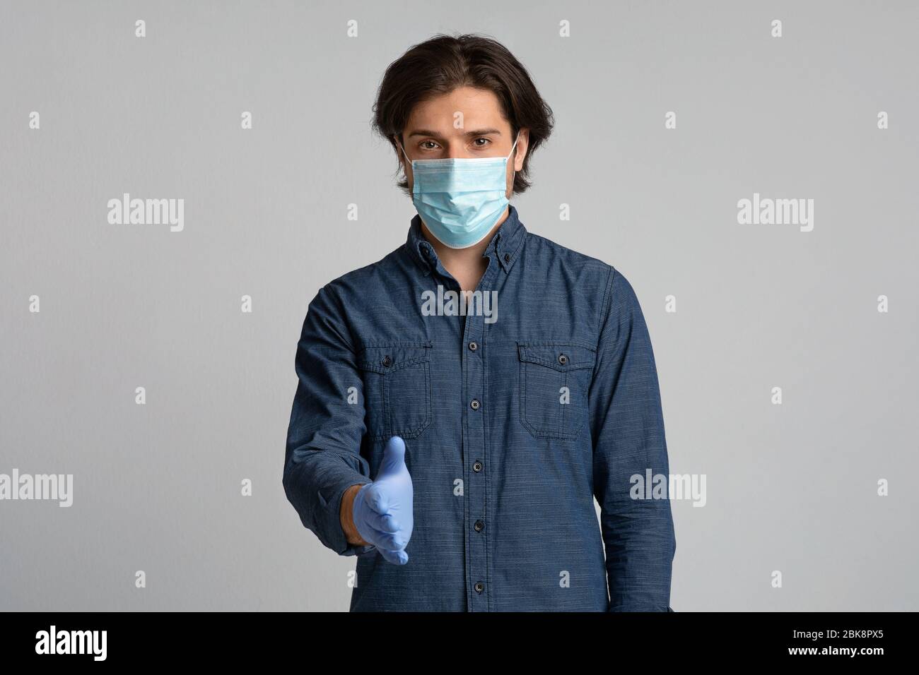 Man extending hand in help hi-res stock photography and images - Alamy