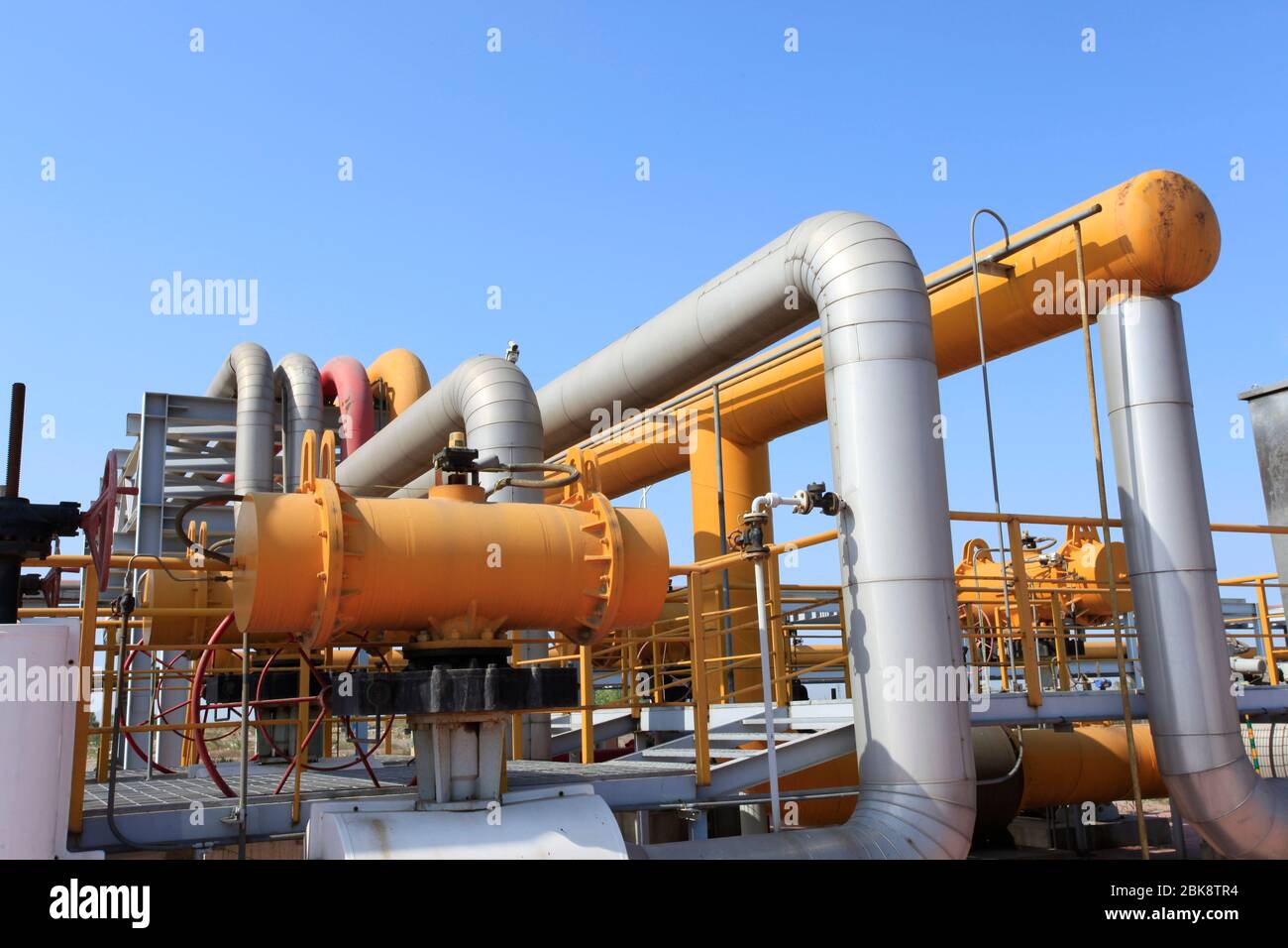 Oil field scene, oil pipelines and facilities Stock Photo - Alamy