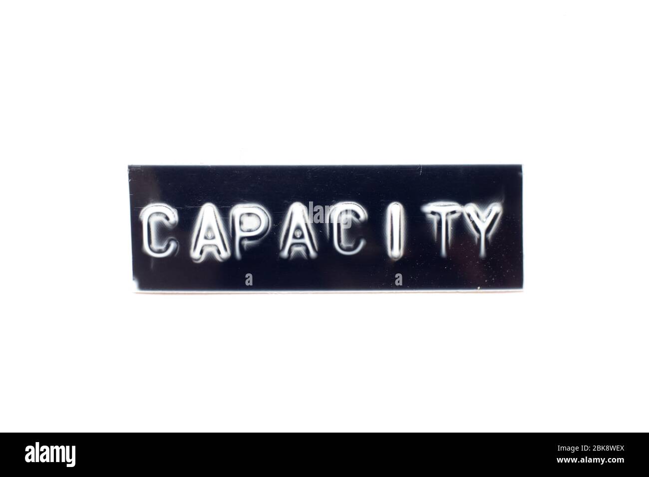 Embossed letter in word capacity in black banner on white background ...