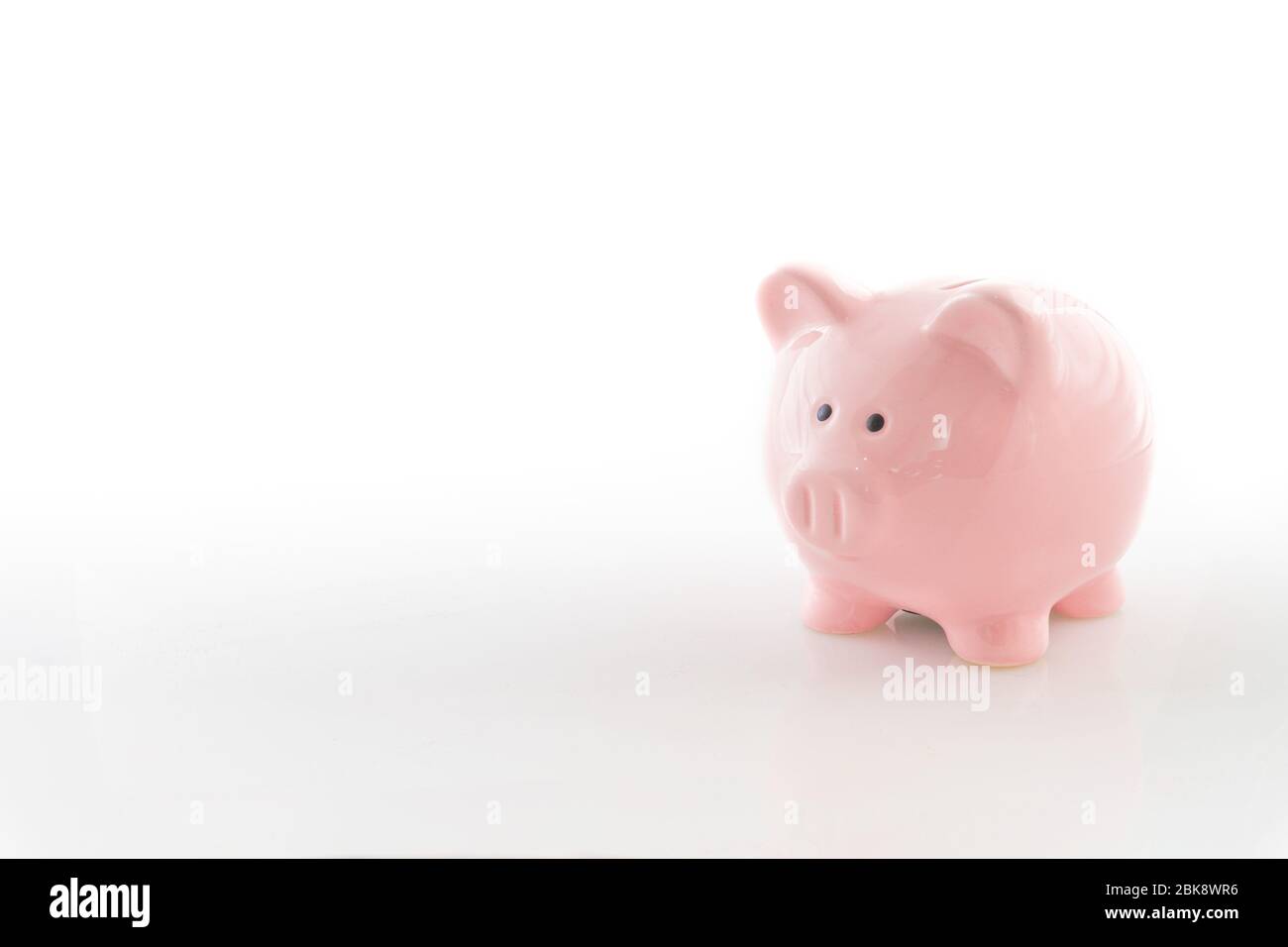 Pink piggy bank isolated on a white background Stock Photo - Alamy