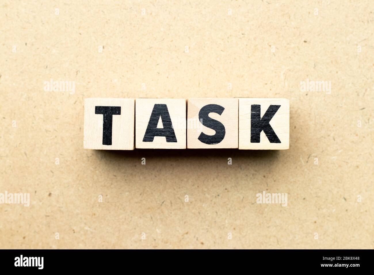 Letter block in word task on wood background Stock Photo - Alamy