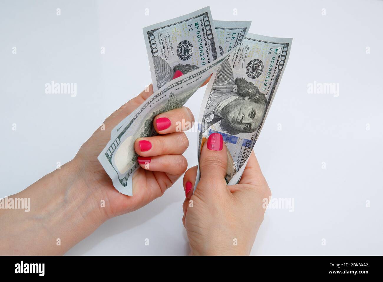 Usd banknote view in female hand on white background Stock Photo - Alamy