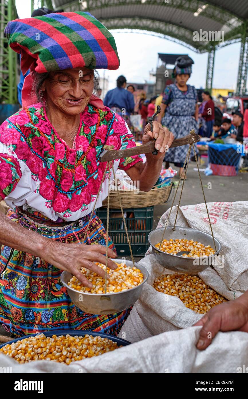 Woman dressed with indigenous colourful outfit selling corn in a local ...