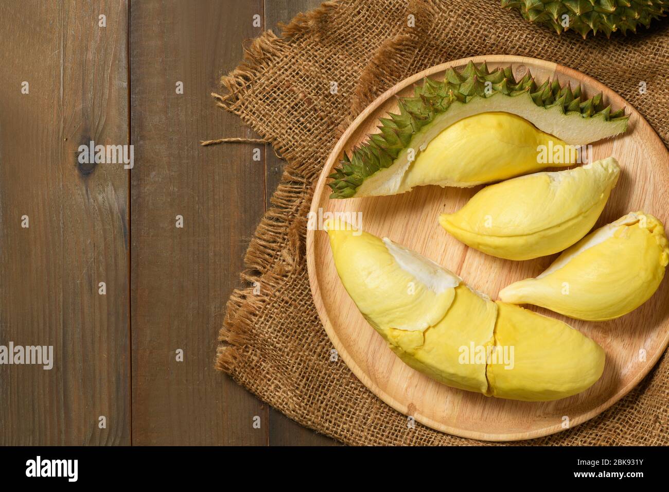 Top view of Fresh durian (monthong) on wood dish and old wood background, king of fruit from ...