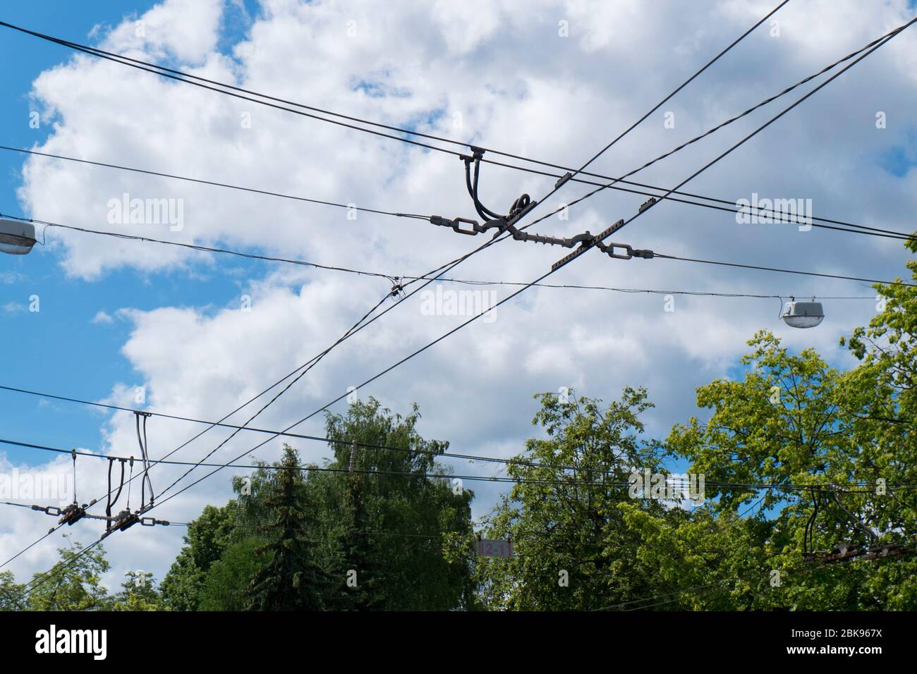 A tangle of overhead, electrified steel cable power lines for buses ...