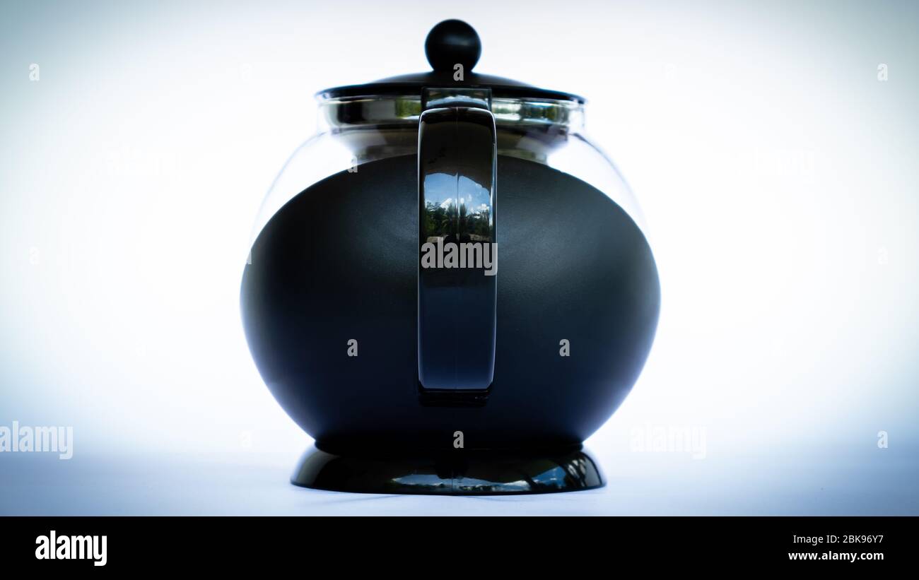 Black glass coffee pot in neutral background back side view Stock Photo ...