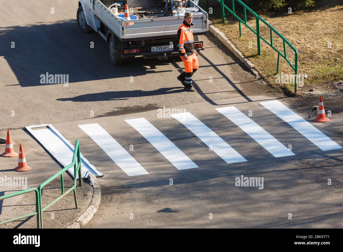 Applying road markings on asphalt using a special machine. Editorial ...