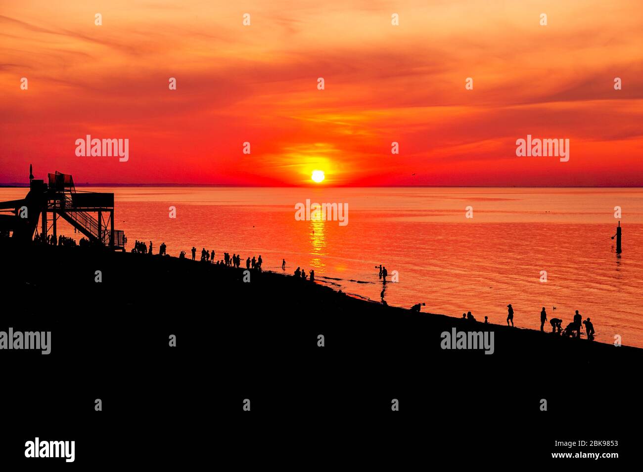 Sunset - sun reflecting in sea/ ocean, beach Stock Photo - Alamy