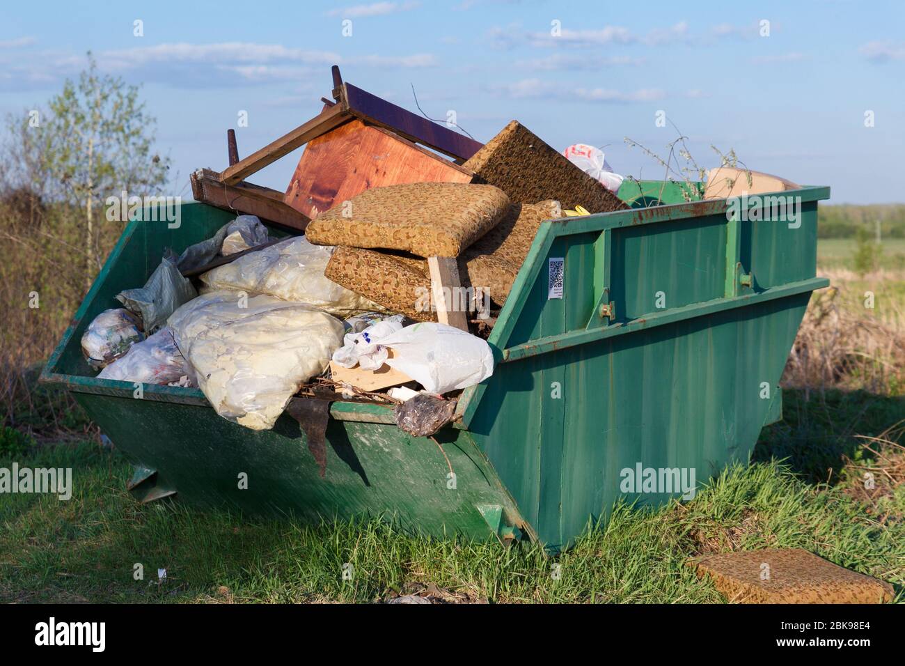 Trash can full of household and construction garbage Stock Photo - Alamy