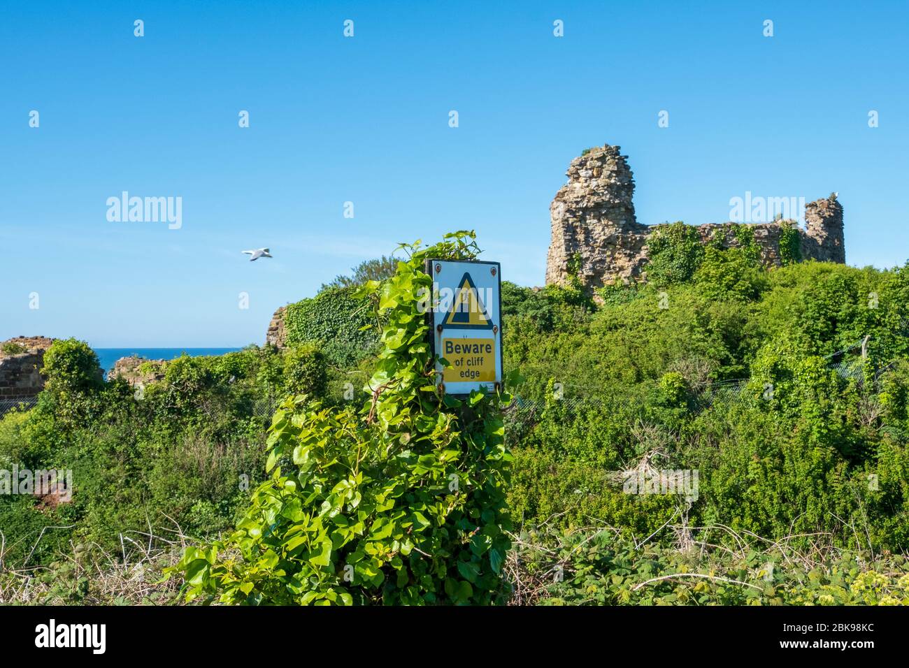 Beware of Cliff Edge sign at Hastings Castle, East Sussex, UK Stock ...