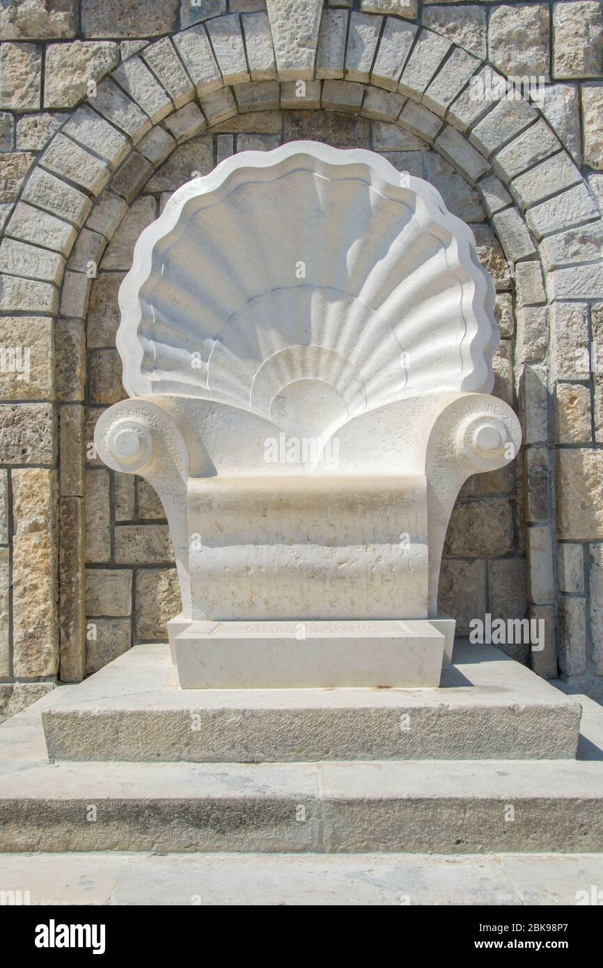 Empty cement throne in shape of a shell, seat, ancient decorative ...