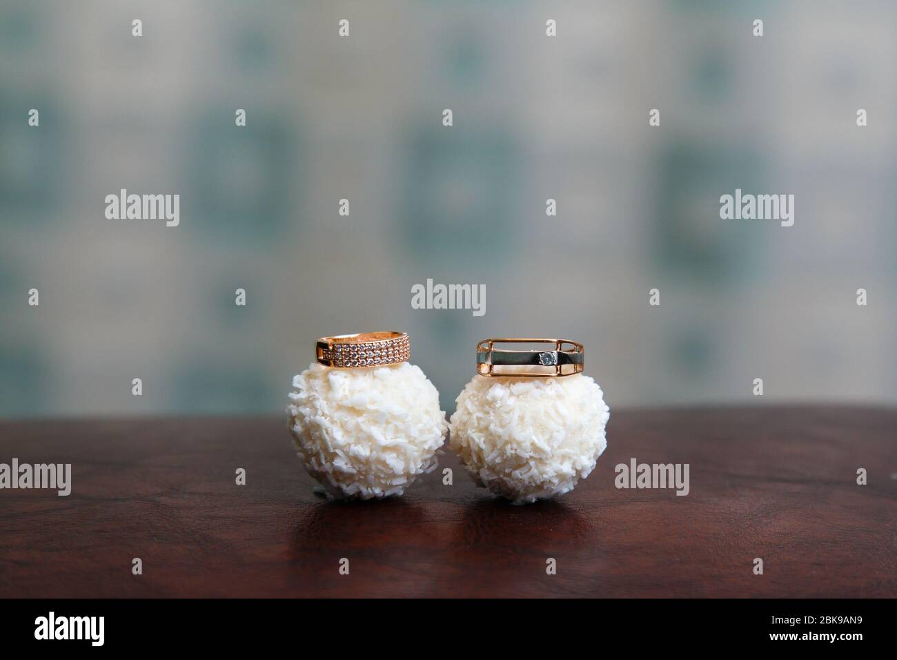 Wedding rings on candy Raffaello Stock Photo - Alamy