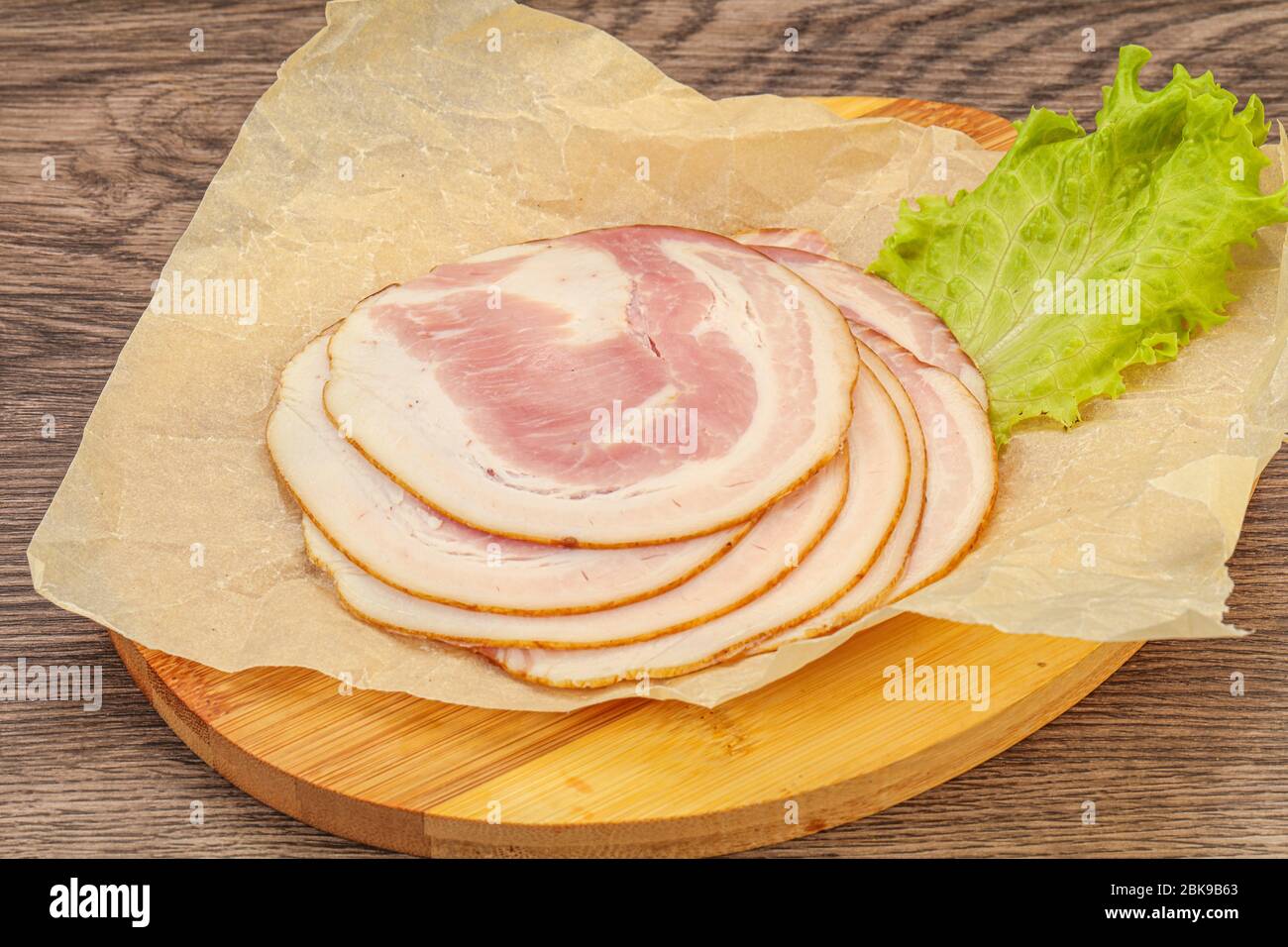 Sliced Italian Pancetta sausage over board Stock Photo - Alamy