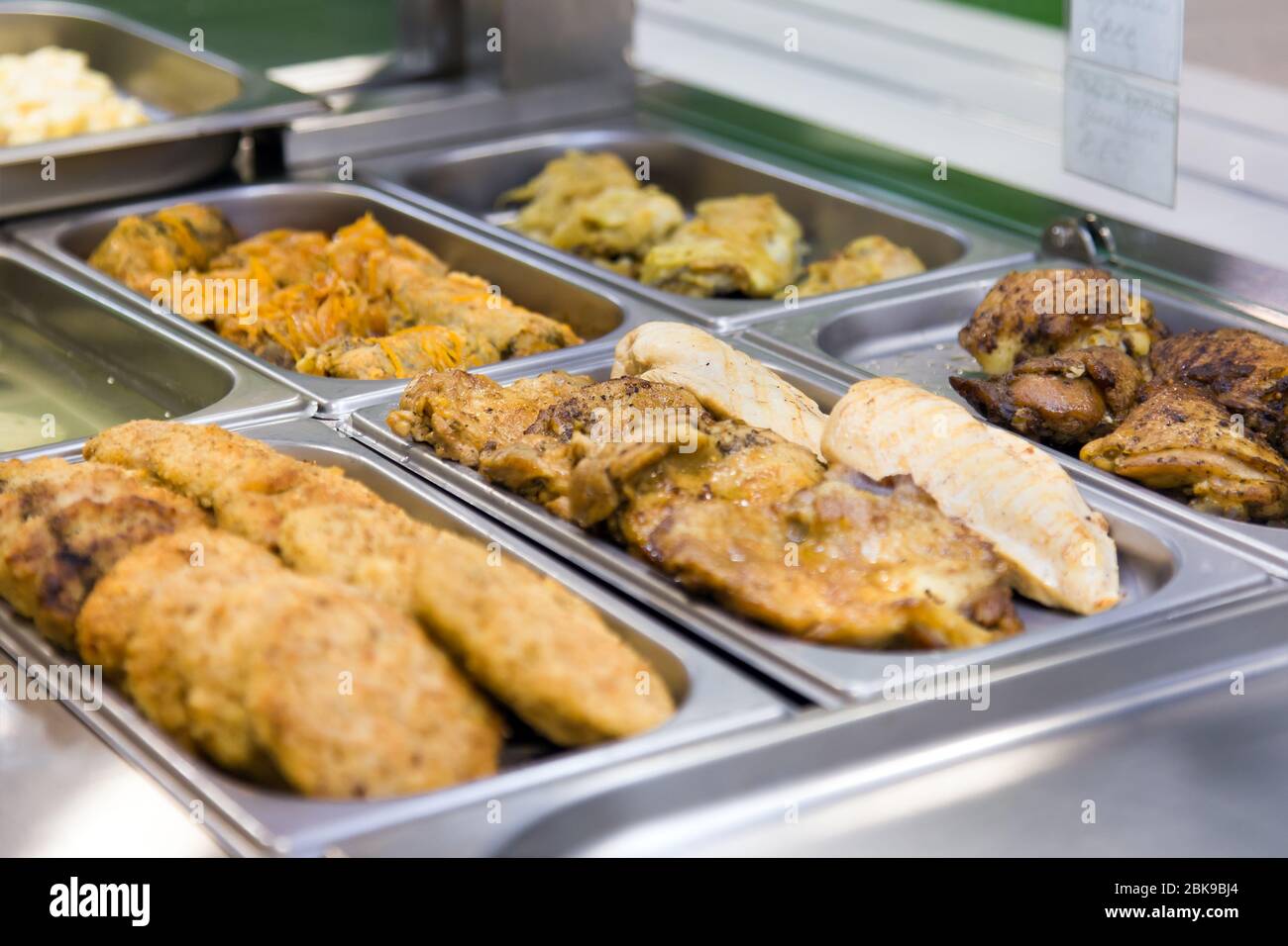 cutlets and meat dishes in buffet on metal plates. selective focus ...