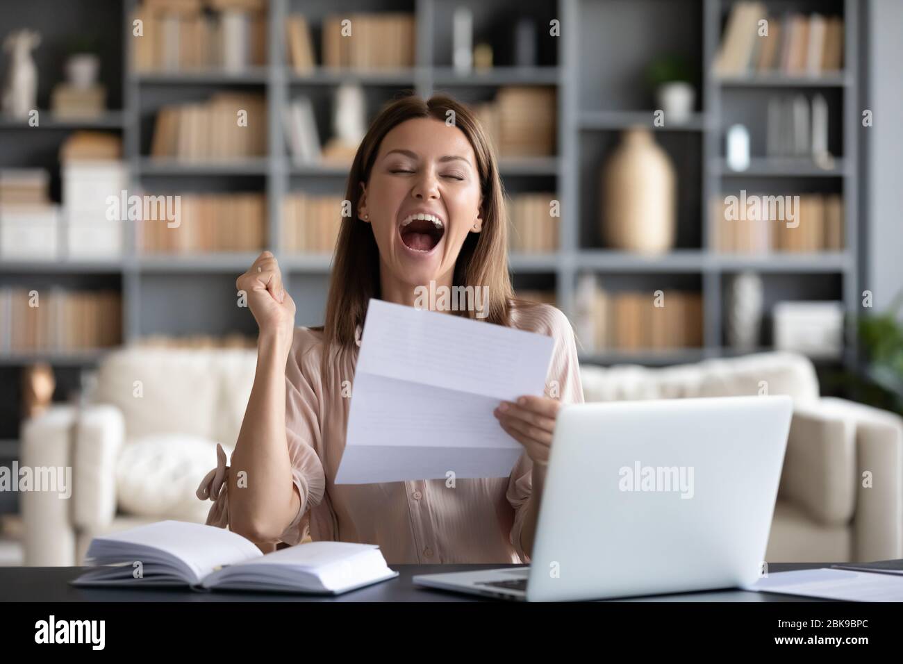 Excited woman reading good news in letter, screaming with joy Stock ...