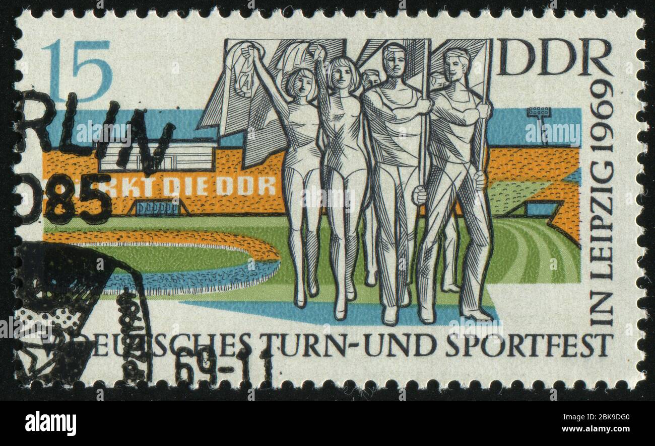 GERMANY- CIRCA 1969: stamp printed by Germany, shows Parading athletes ...