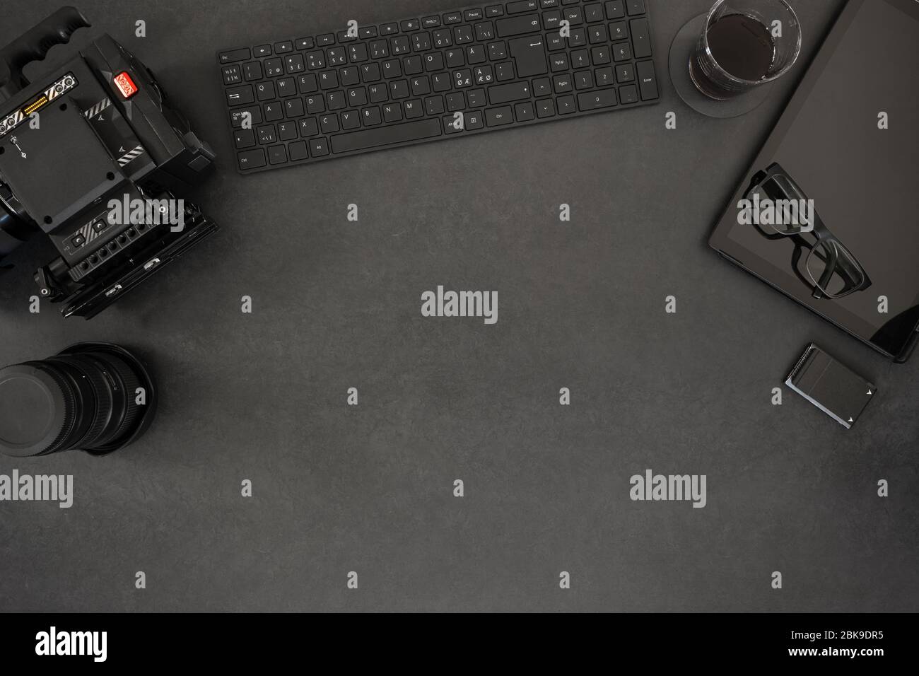 Directly above shot of computer and photographic equipment on table ...