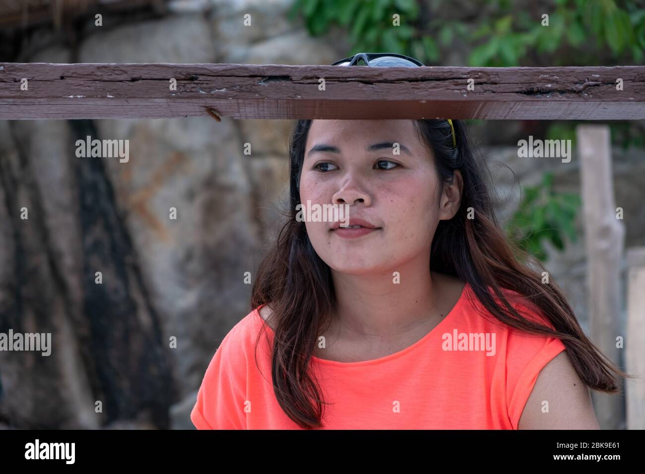 An Asian lady is thinking alone. Thai lady sitting alone outside Stock ...
