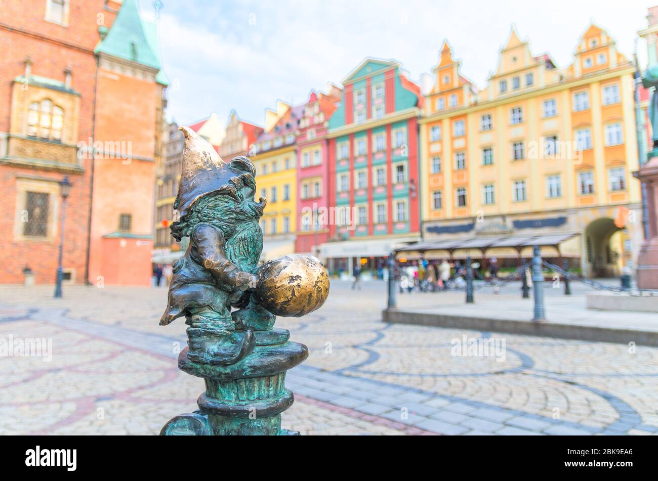 Wroclaw, Poland, May 7, 2019: Dwarf is sitting on street water tap on ...