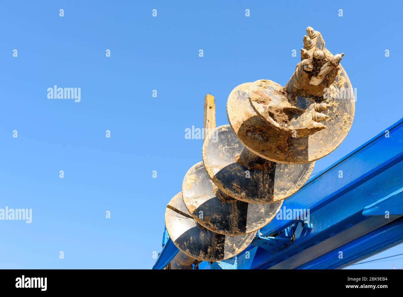 Tracer tractor with auger for soil drilling for piles installation ...