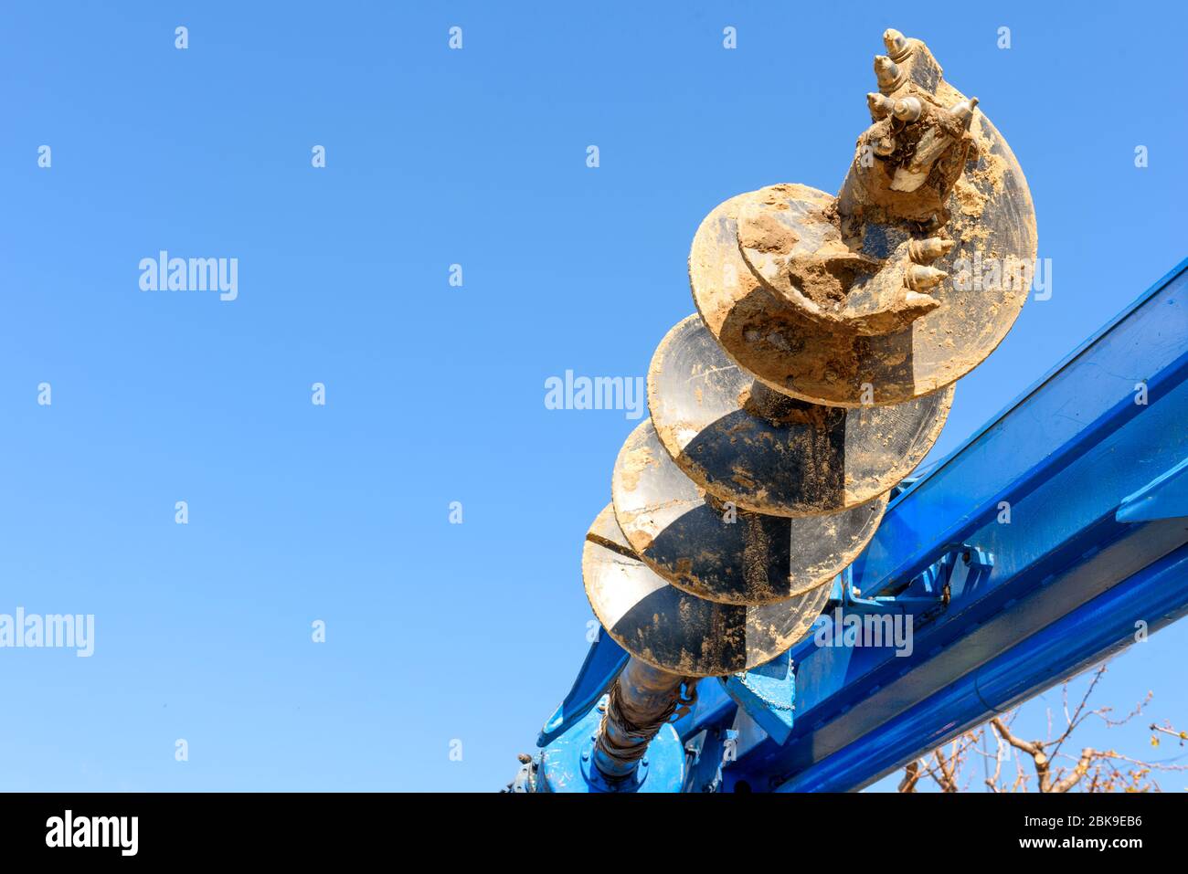 Tracer tractor with auger for soil drilling for piles installation ...