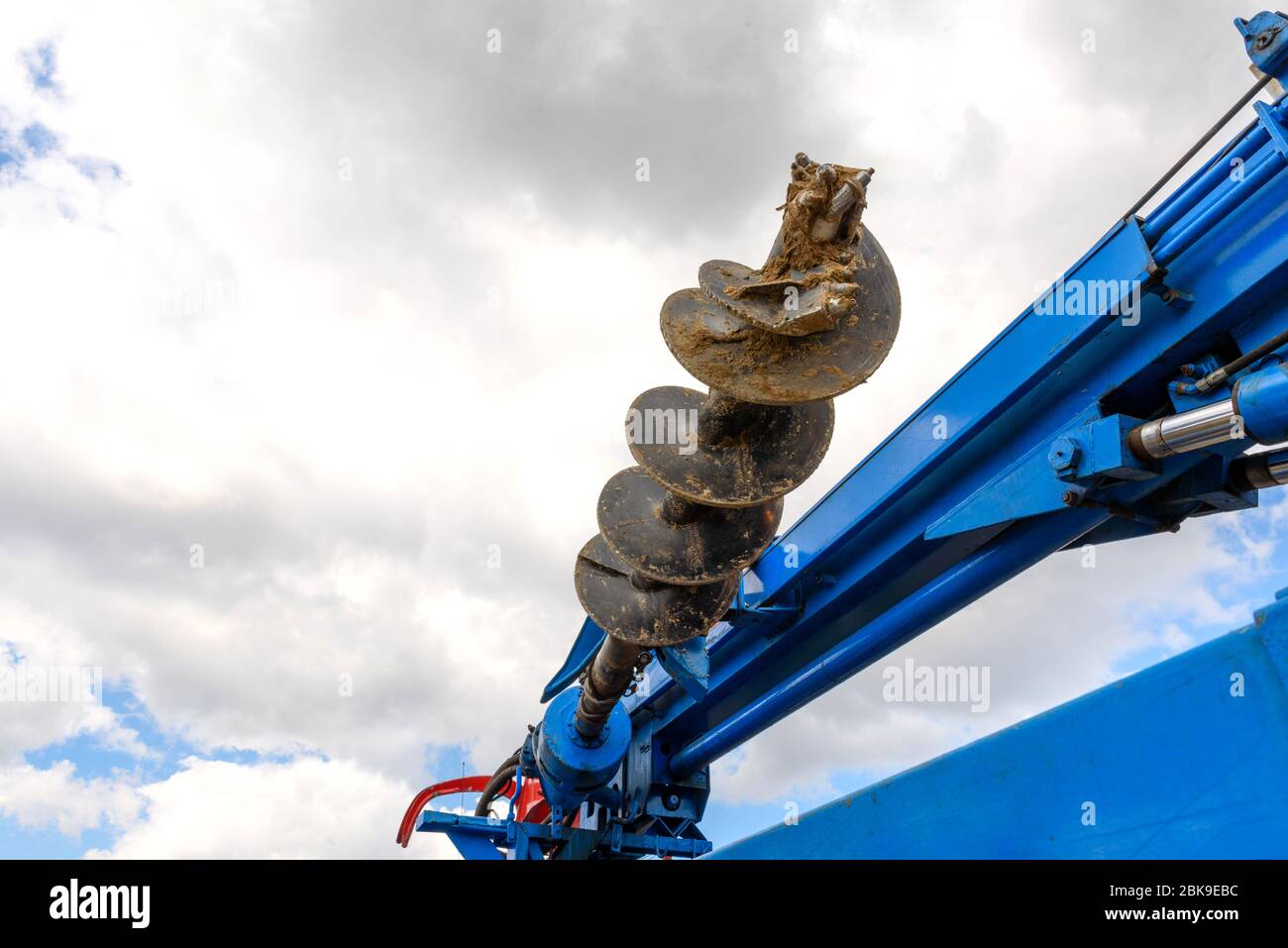 Tracer tractor with auger for soil drilling for piles installation ...