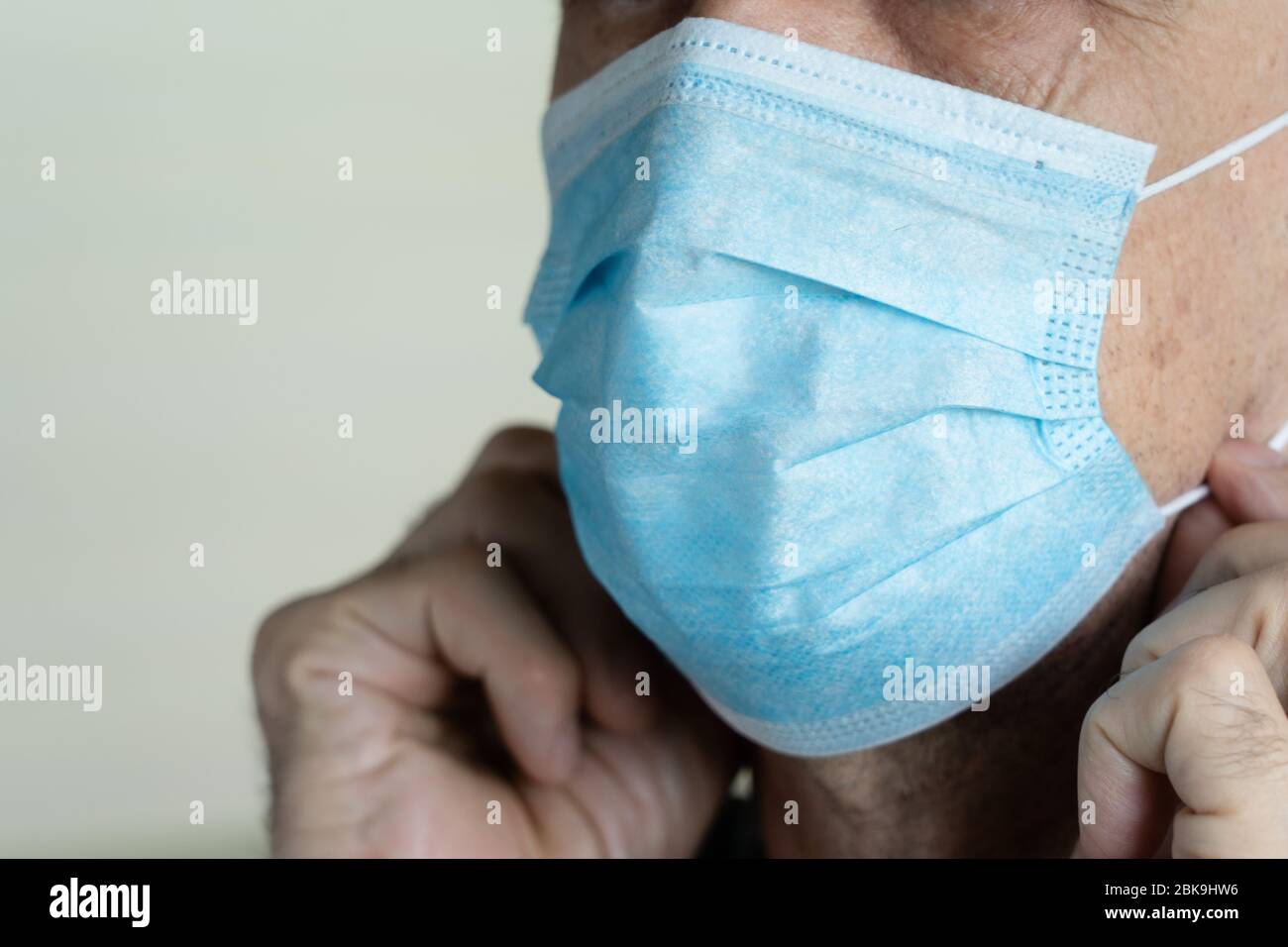 Medical mask on an old man Stock Photo - Alamy