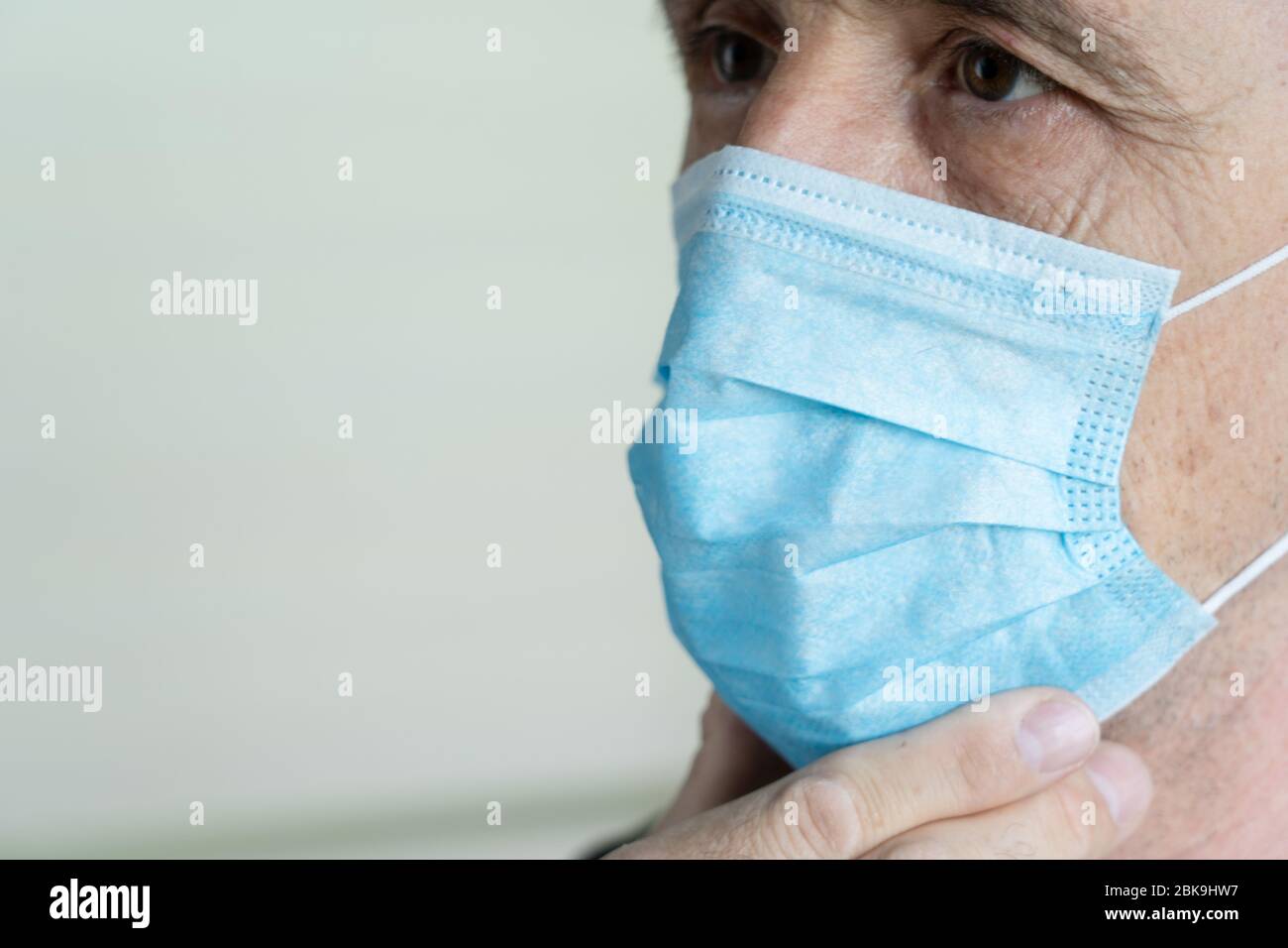 Medical mask on an old man Stock Photo - Alamy