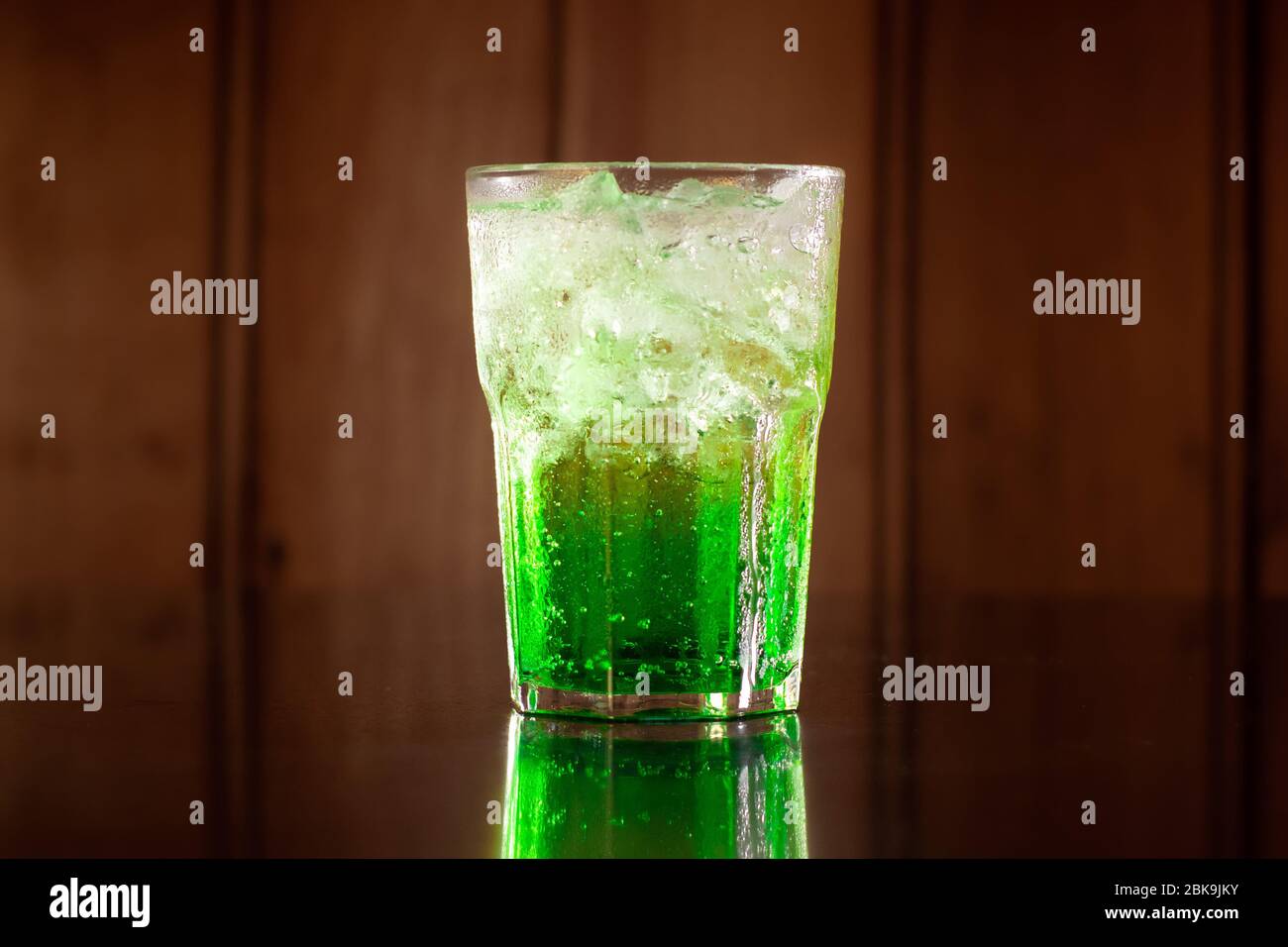 green alcholol cocktail on wood background Stock Photo - Alamy