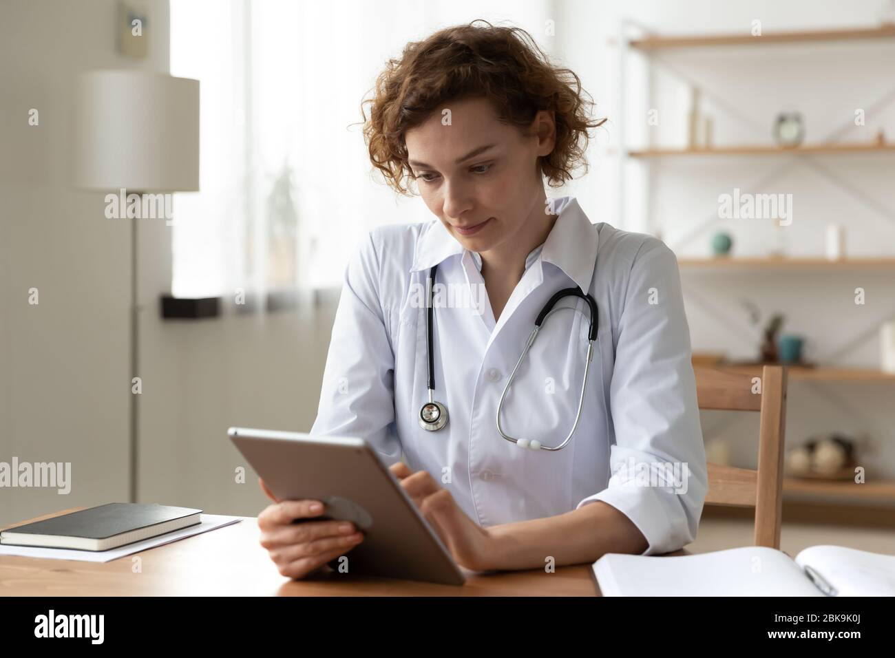 Serious professional doctor using digital tablet computer at work Stock ...