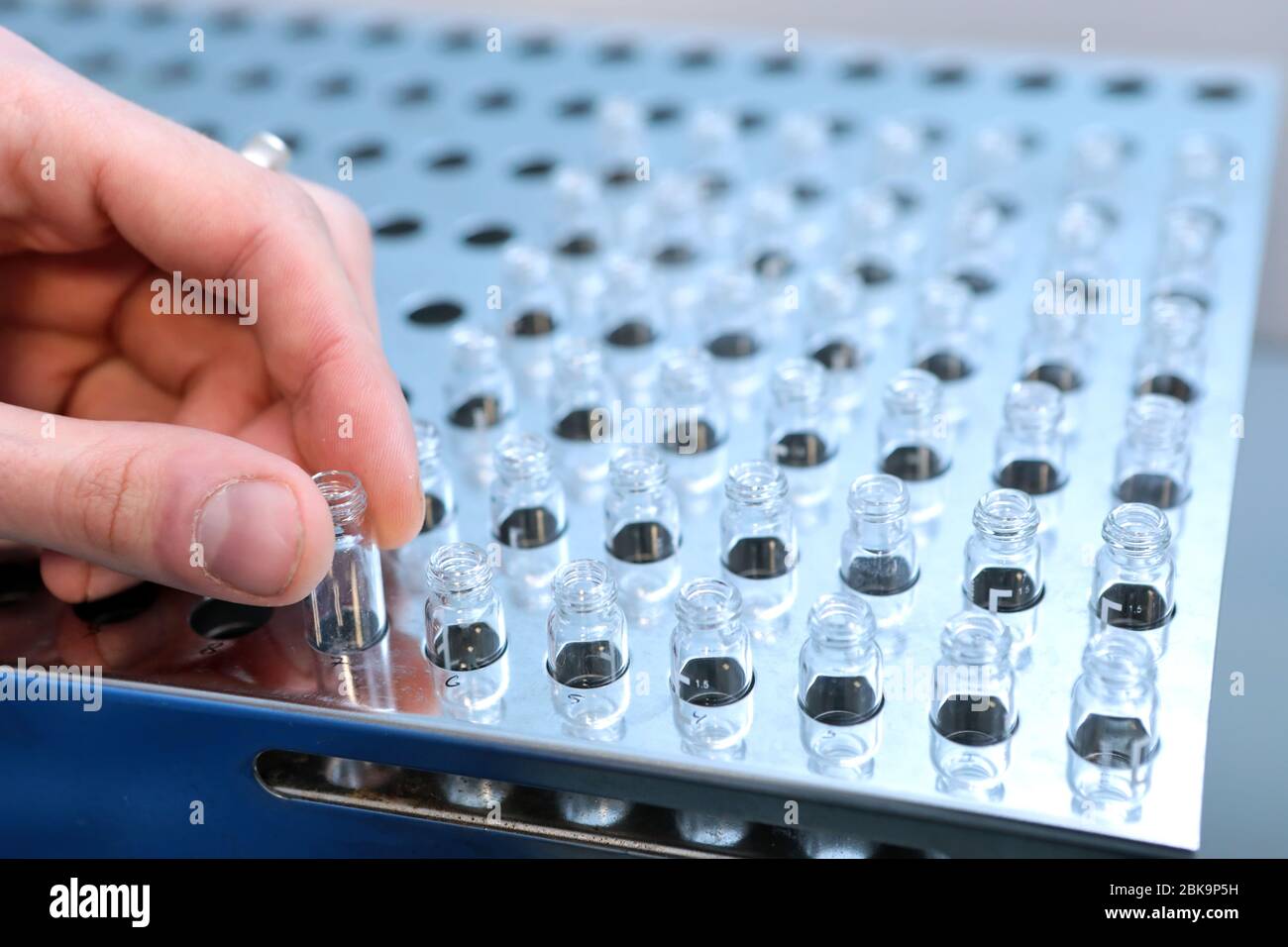 Scientist holds a chemical sample bottle. Doctor hand in medical glove ...