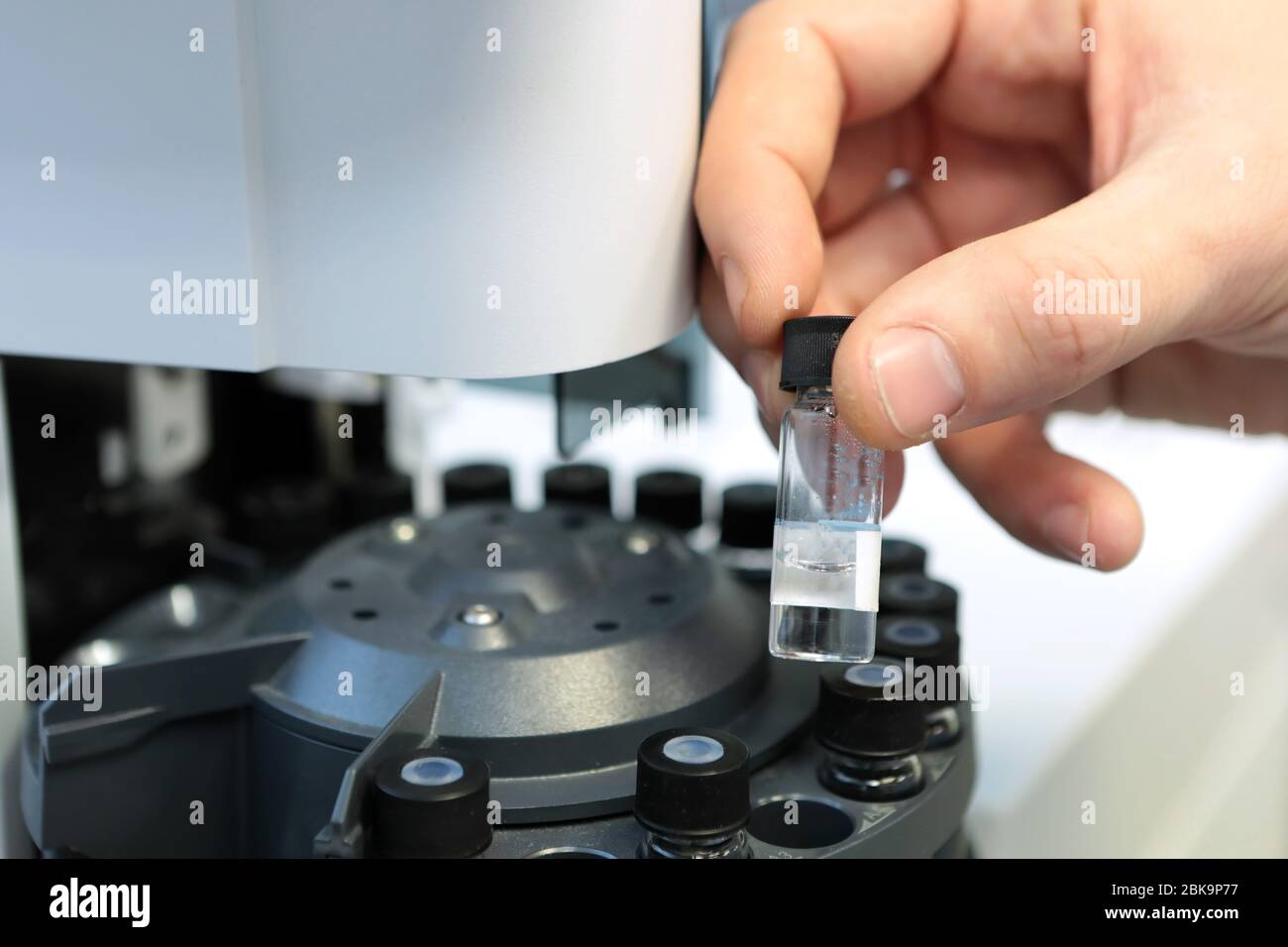 Scientist holds a chemical sample bottle. Doctor hand in medical glove ...