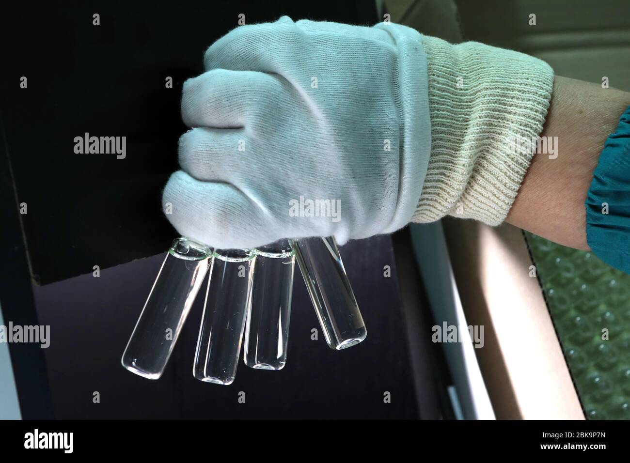 Scientist holds a chemical sample bottle. Doctor hand in medical glove ...
