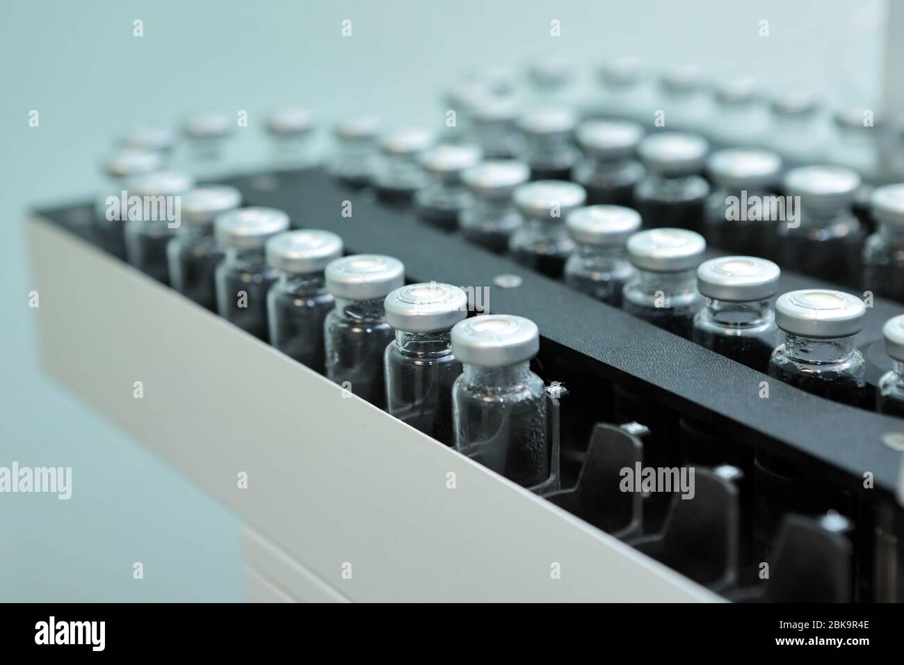 Sterile bottles and ampoules on the dispensing line. Sealed ampoules ...