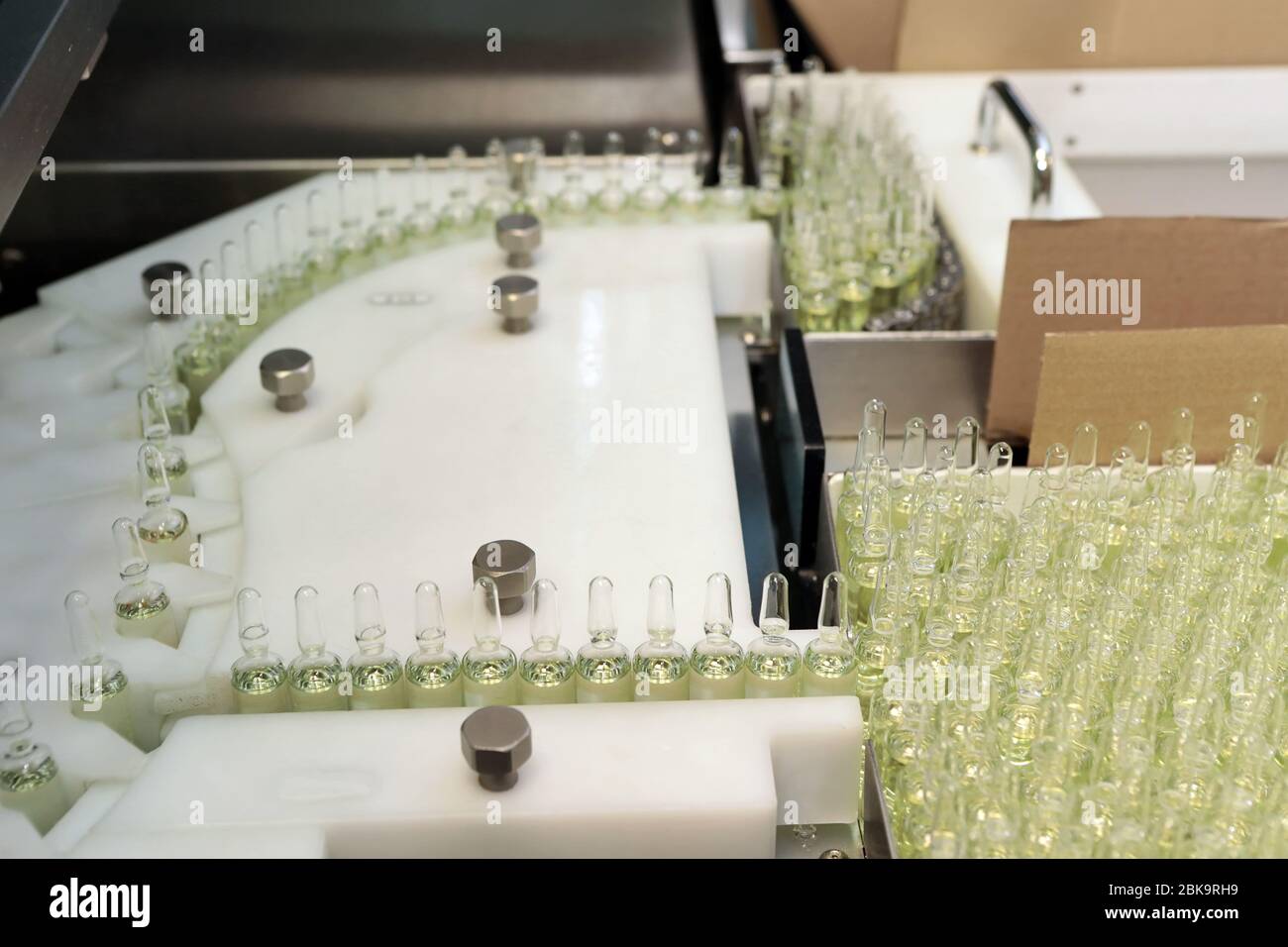 Sterile bottles and ampoules on the dispensing line. Sealed ampoules ...