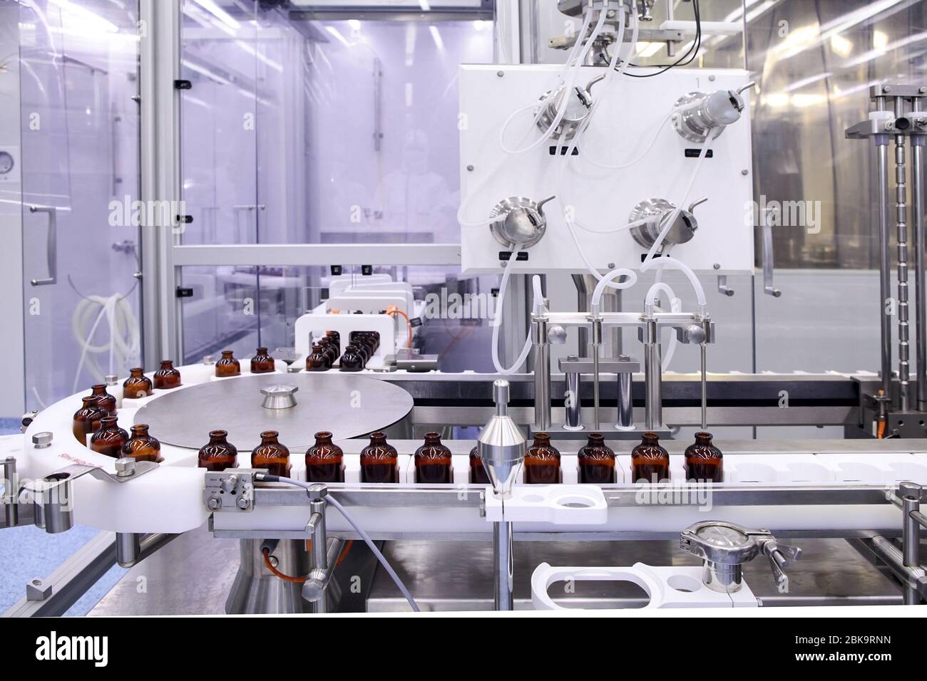 Sterile bottles and ampoules on the dispensing line. Sealed ampoules ...
