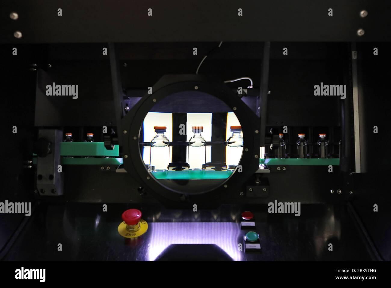 Quality Control vials for injection. Individual checks vial under a ...