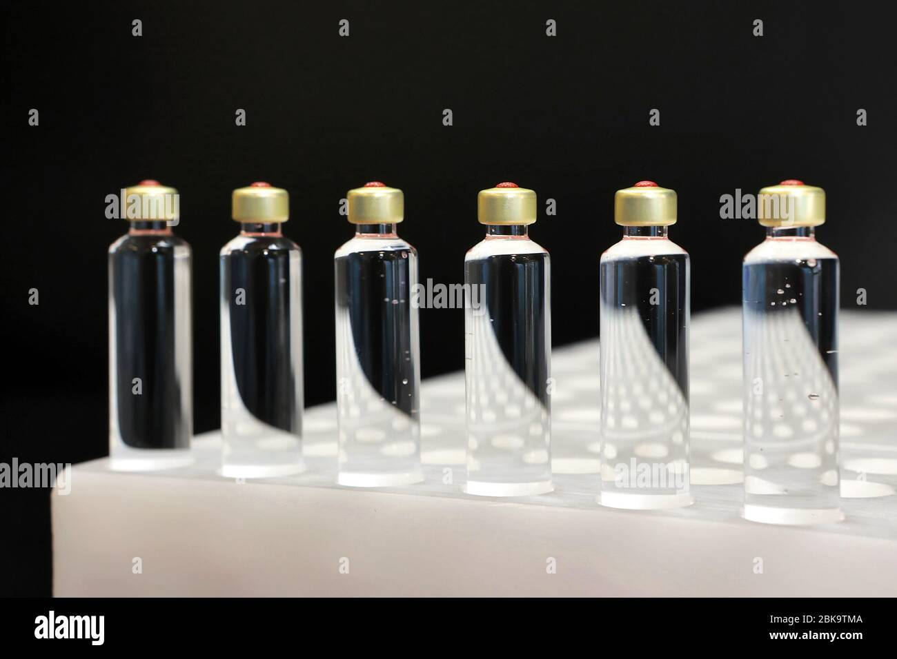 Quality Control vials for injection. Individual checks vial under a ...