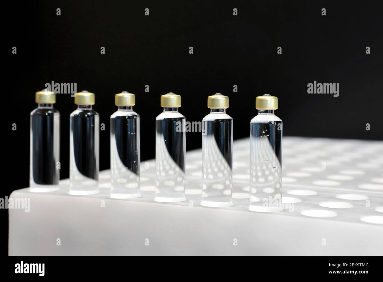 Quality Control vials for injection. Individual checks vial under a ...
