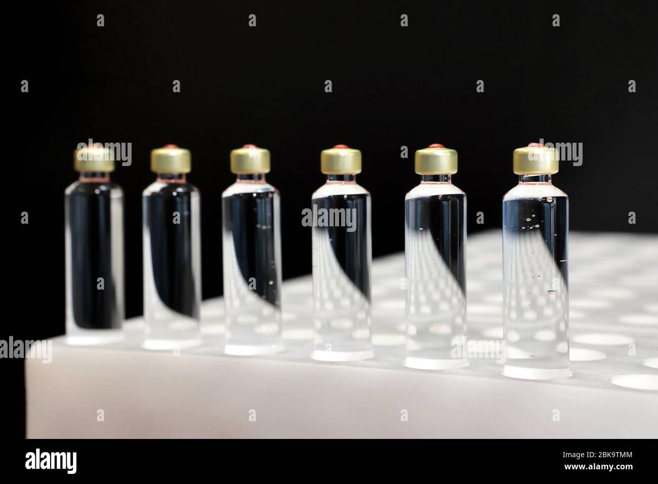 Quality Control vials for injection. Individual checks vial under a ...