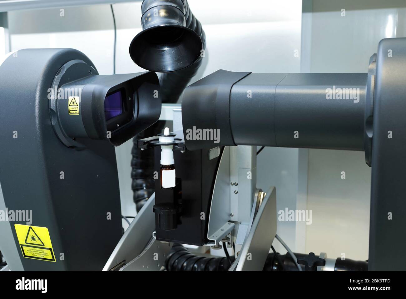 The worker measures the size of the particles and drops of the spray ...