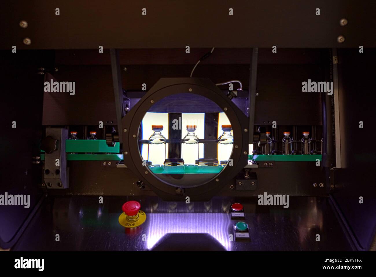 Quality Control vials for injection. Individual checks vial under a ...