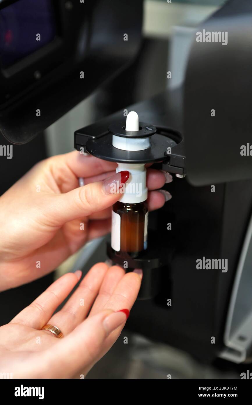 The worker measures the size of the particles and drops of the spray ...