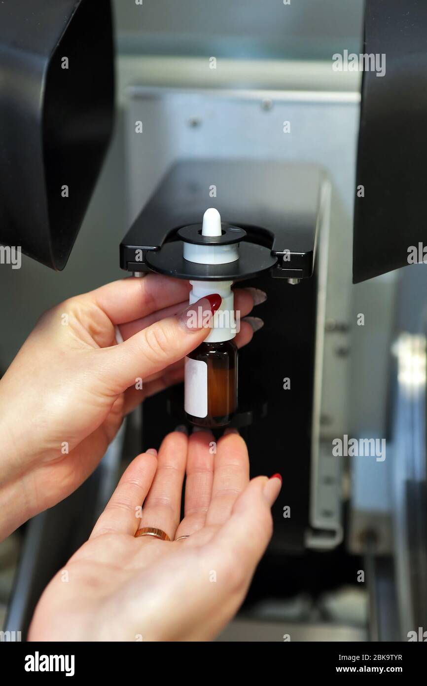 The worker measures the size of the particles and drops of the spray ...