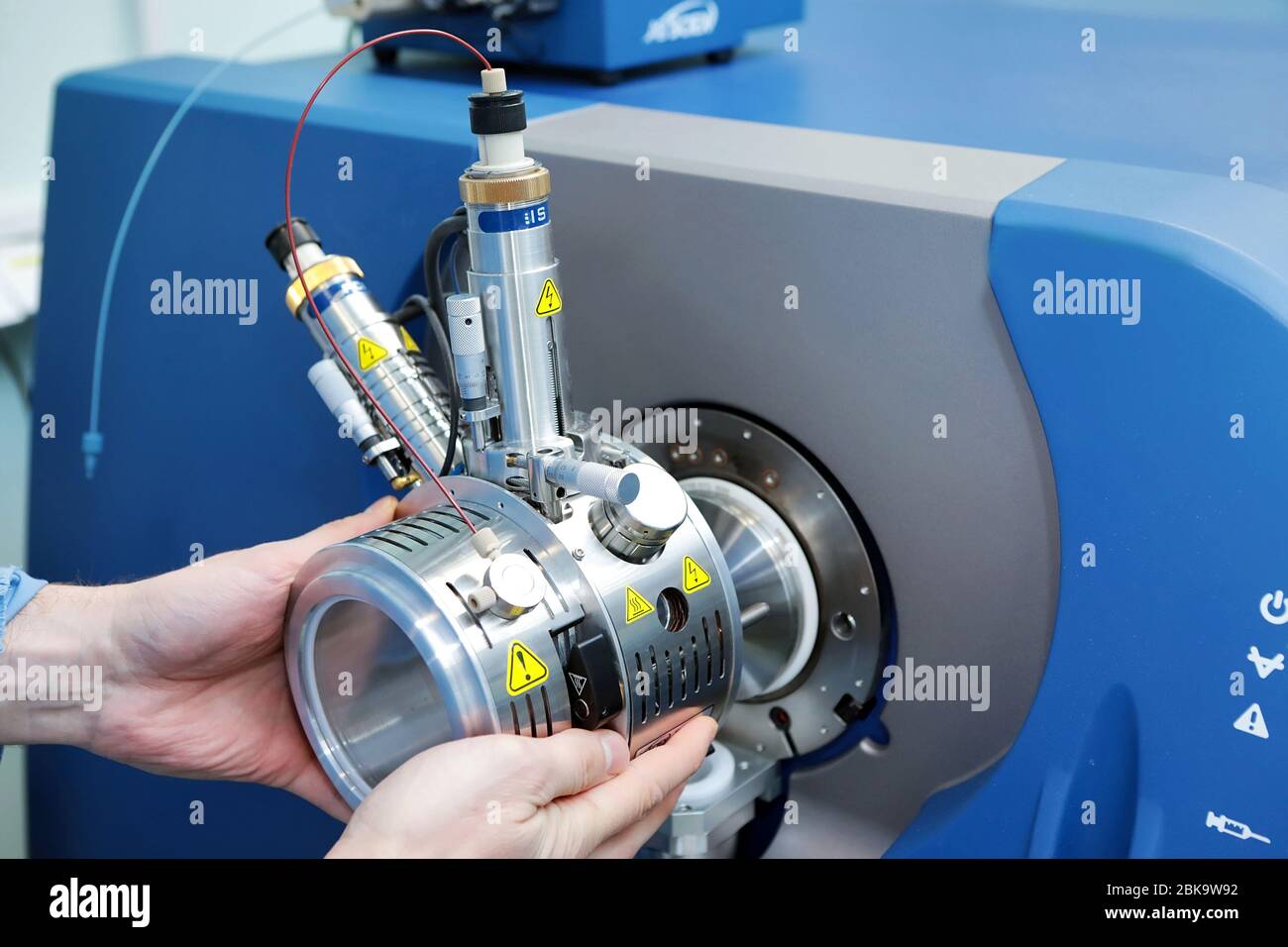 Adjust the mass spectrometer. The man analyzes the device for ...