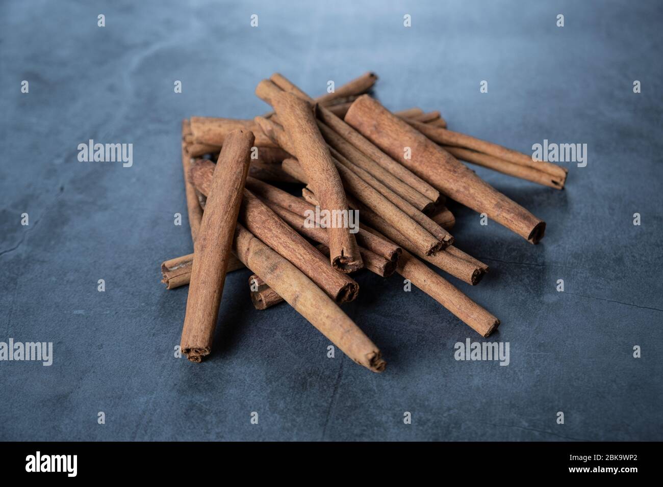 Cinnamon sticks on concrete, stone background Stock Photo - Alamy
