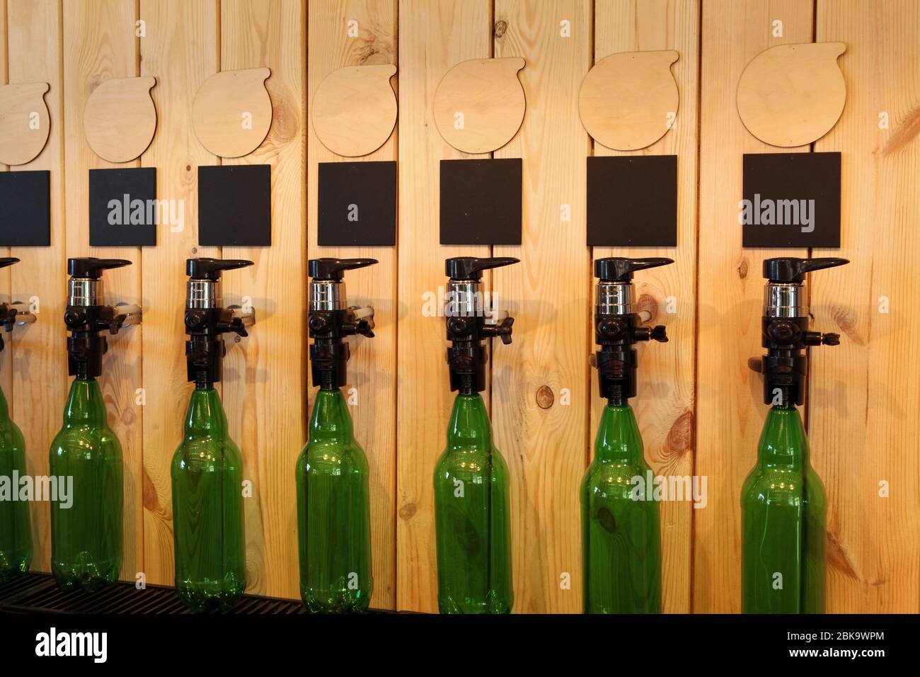 Large simultaneous spilling beer in the bar. The bar of wood. Wooden ...