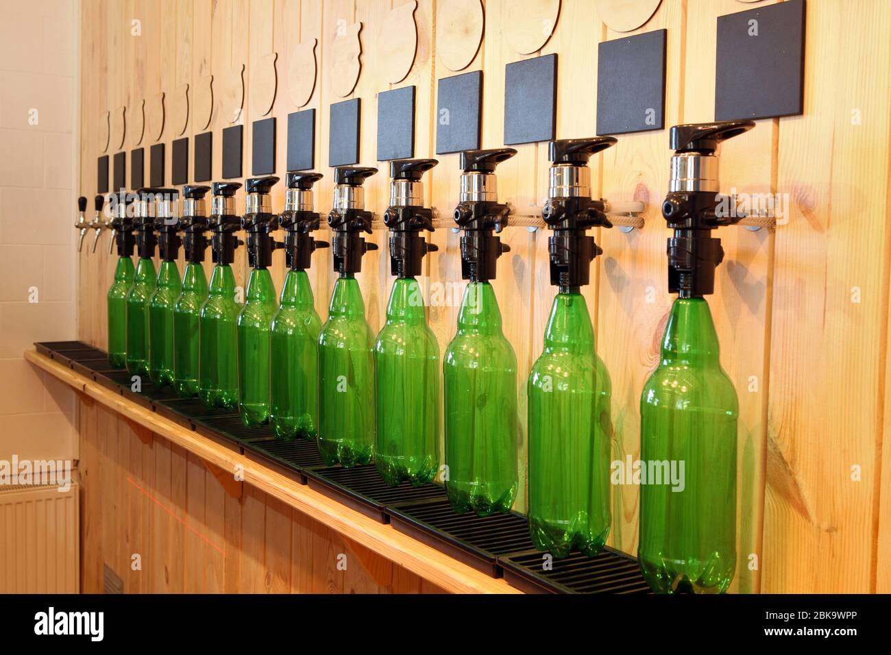 Large simultaneous spilling beer in the bar. The bar of wood. Wooden ...